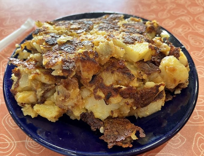 Lyonnaise potatoes arrive golden and glorious, thin-sliced and caramelized into crispy coins of pure breakfast currency.