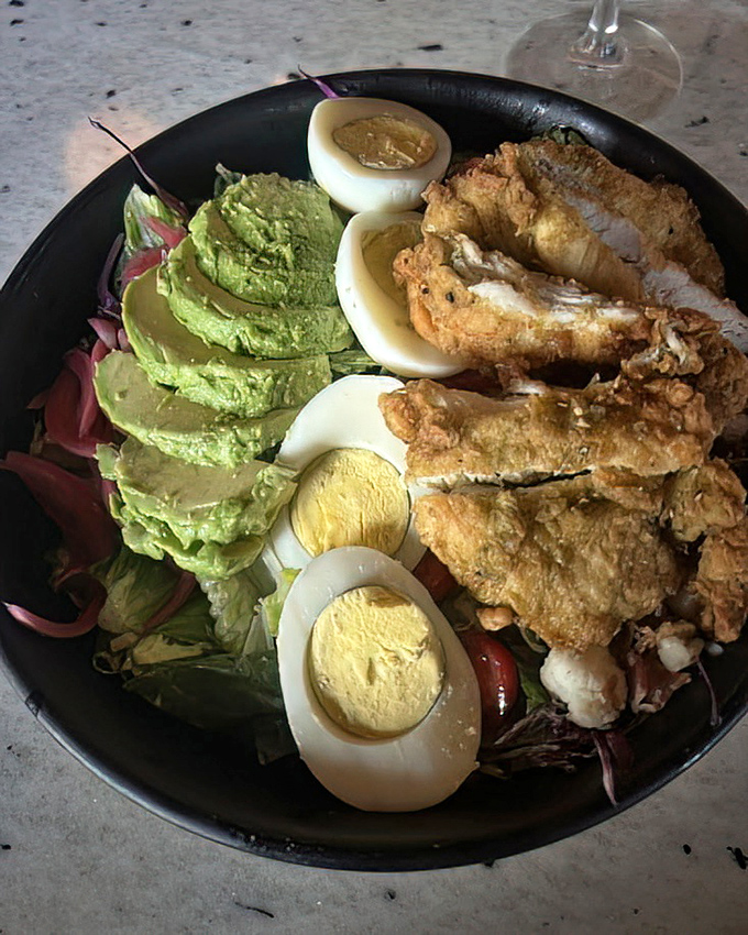 This Cobb salad redefines the genre&mdash;crispy chicken, perfect eggs, and fresh avocado arranged with such care it's practically edible modern art.