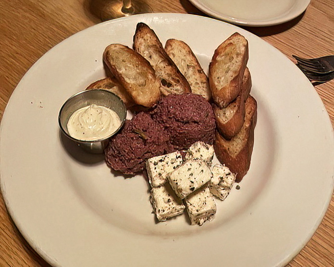 An appetizer board that celebrates simplicity and sophistication. Rustic bread meets velvety spreads in a starter that sets the stage for greatness.