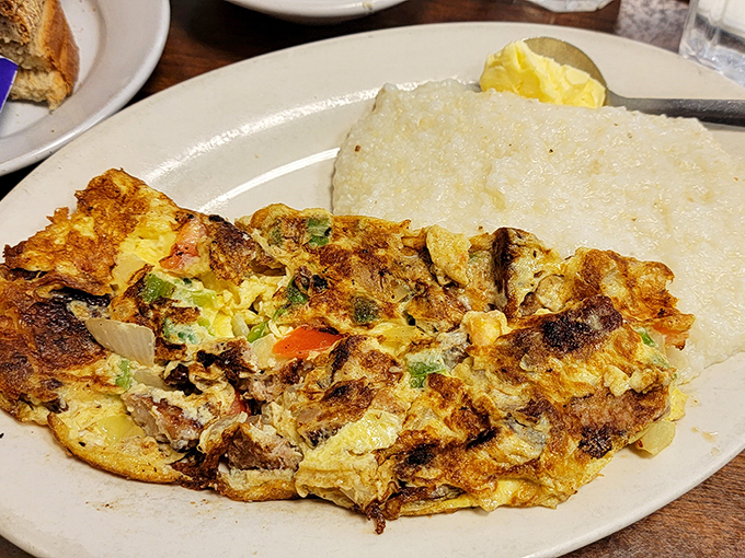 This omelet has more fillings than your average novel has plot twists. Paired with creamy grits&mdash;a breakfast that demands to be savored.