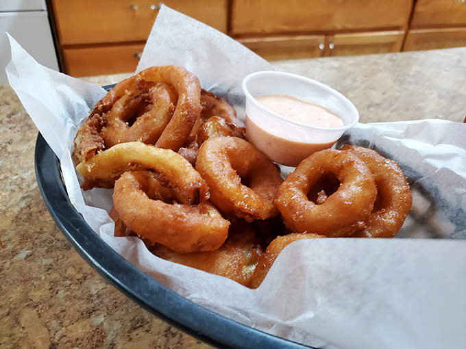 Onion rings with that perfect crunch-to-tenderness ratio, served with a dipping sauce that makes you question all other condiment relationships.