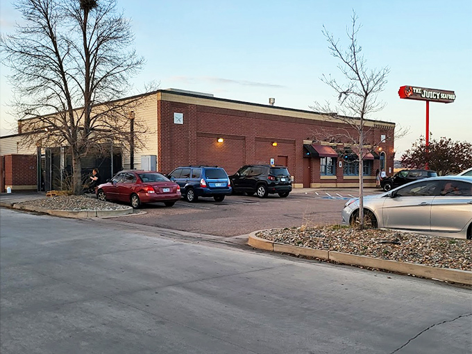 As dusk approaches, The Juicy Seafood's exterior takes on an inviting glow. Your car will practically park itself.