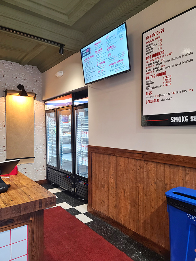 Clean lines, wooden accents, and that menu board – the calm before the flavor storm. This isn't just a restaurant; it's a temple of smoke.