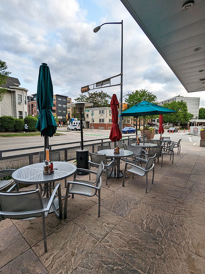 Outdoor seating at Bassett Street – where fresh air enhances appetite and colorful umbrellas stand ready to shield your precious cheese curds from rain.