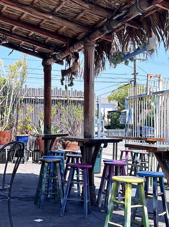 Colorful stools under a rustic palapa create the perfect stage for the main event: your imminent taco happiness.
