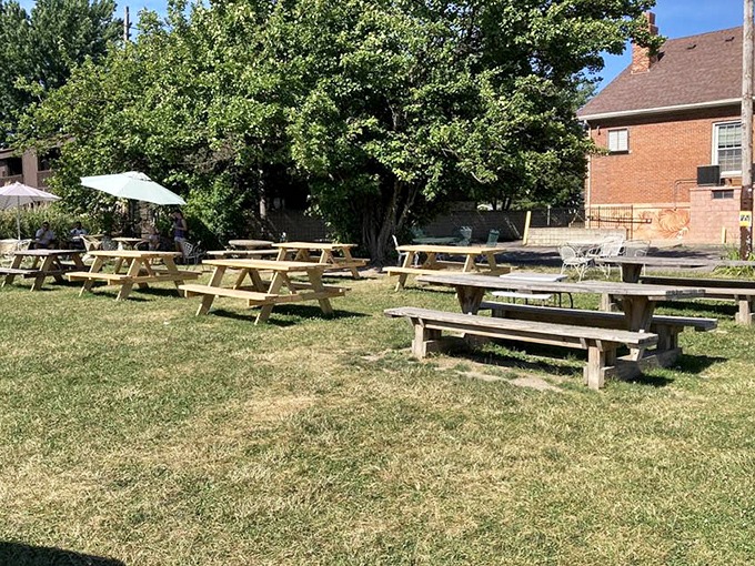 Picnic tables waiting for ice cream enthusiasts. This outdoor seating area transforms into a community gathering spot when cones and cups are in hand.