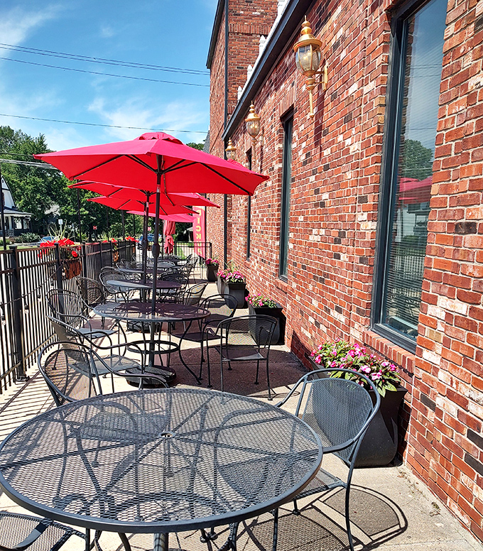 The outdoor patio offers al fresco dining under cheerful red umbrellas, perfect for people-watching in downtown Danville.