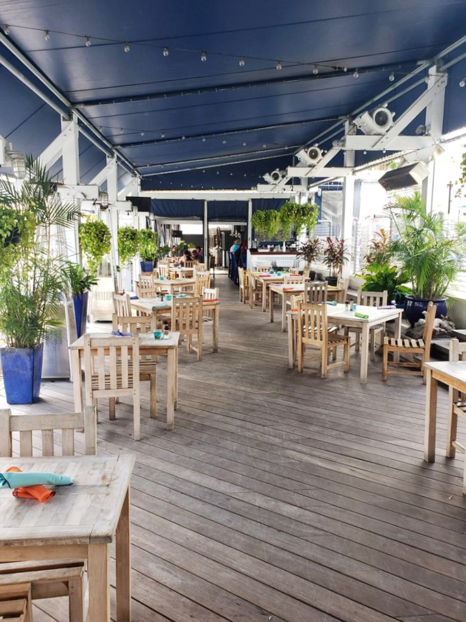 The outdoor deck offers breezy dining under string lights, where wooden tables await seafood feasts and vacation memories in the making.