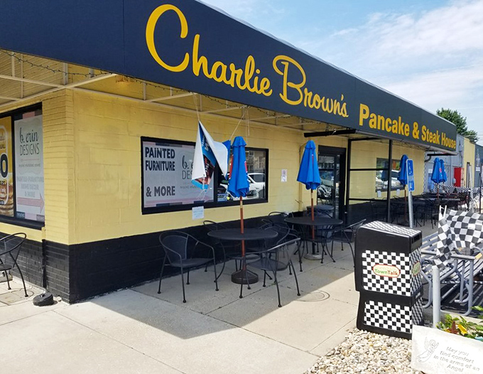 The outdoor seating area with its cheerful blue umbrellas offers al fresco dining for those rare perfect Indiana mornings.