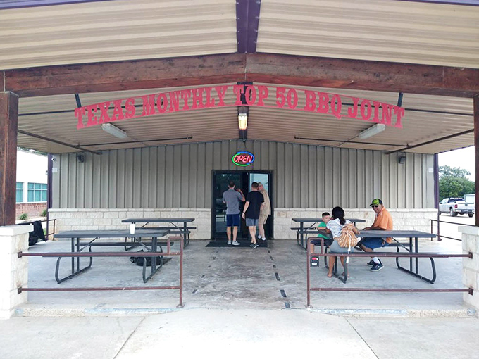 The covered porch where patience is rewarded, as hungry pilgrims wait their turn for what locals know is among Texas' top 50 BBQ joints.