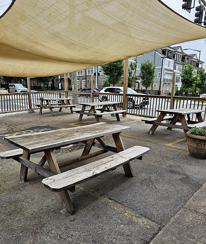 The outdoor seating area under canvas shade offers a perfect spot to recover from the delicious food coma you've willingly entered.