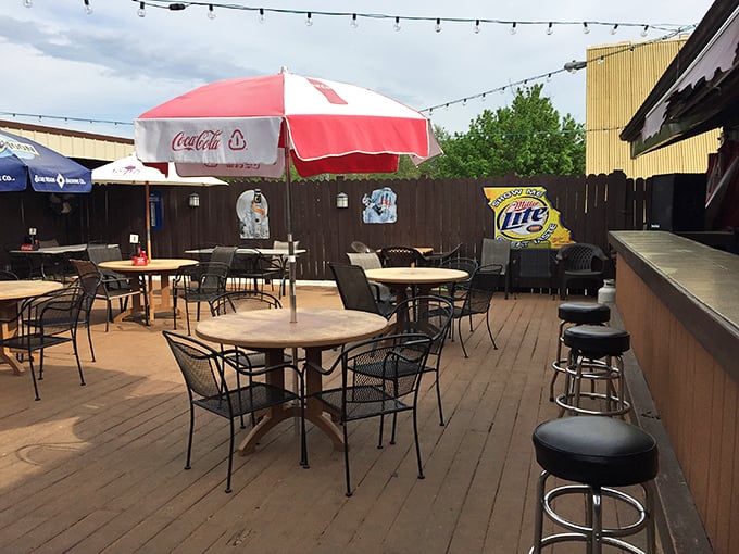 The outdoor patio waits patiently under string lights and Coca-Cola umbrellas for evening breezes and post-meal conversations to begin.