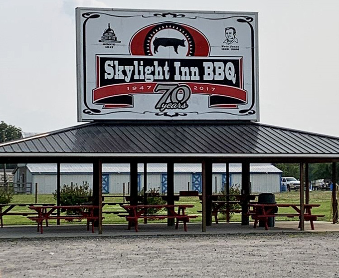 The outdoor pavilion where barbecue pilgrims gather. That sign proudly proclaiming 70 years of excellence is no exaggeration—it's a timeline of deliciousness.