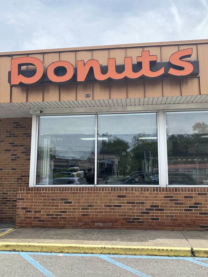 That brick exterior and bold signage announce "DONUTS" like it's the most important word in the English language, which honestly it might be.