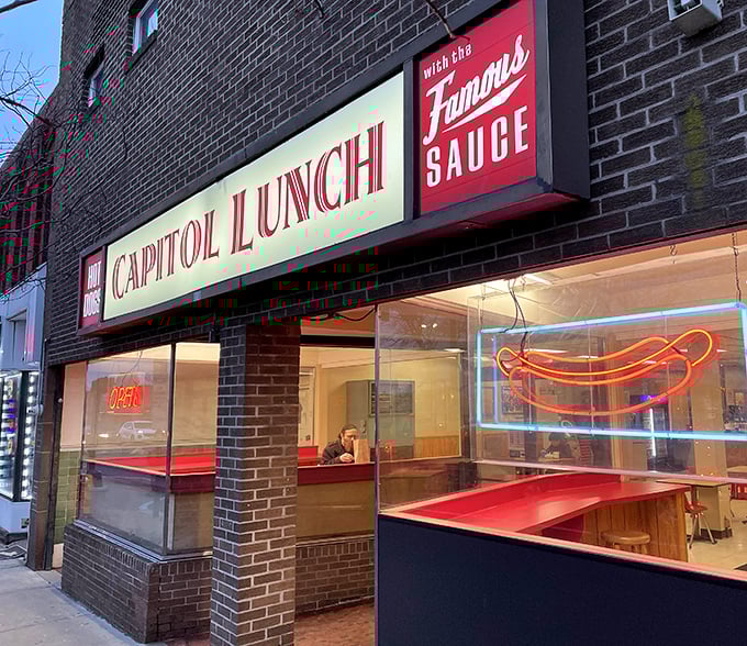 Even at night, that neon hot dog sign glows like a beacon for the hungry. Some might call it tacky; regulars call it a lighthouse guiding them home.