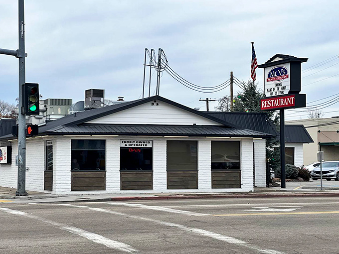 The white exterior with dark trim and American flag presents a classic small-town diner profile. In a world of culinary trends, Mr. V's stands for timeless satisfaction.