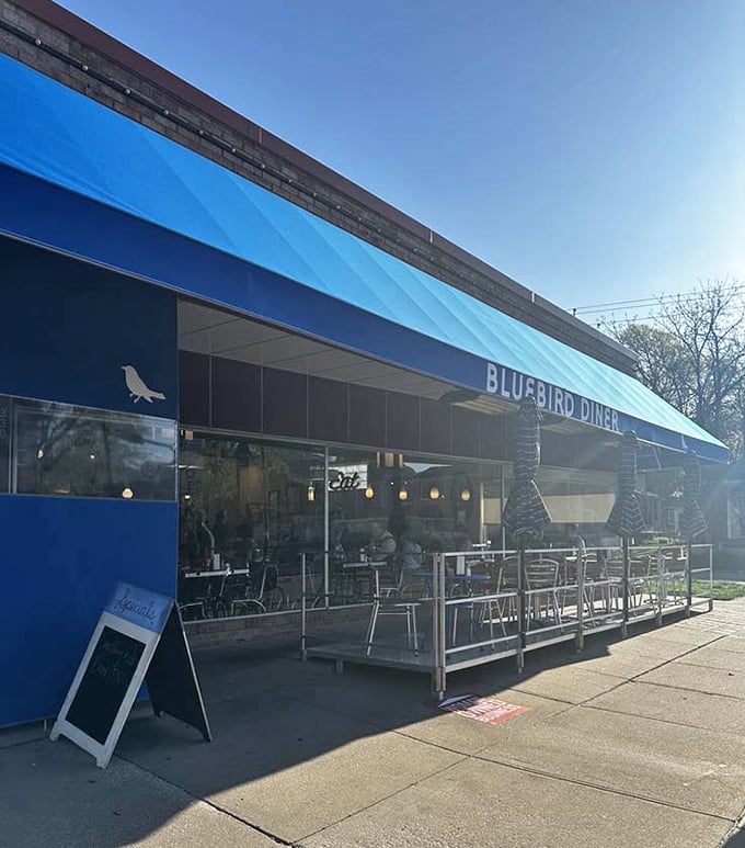 The blue awning creates a perfect frame for lazy weekend mornings, where time slows down and pancakes are always the right answer.