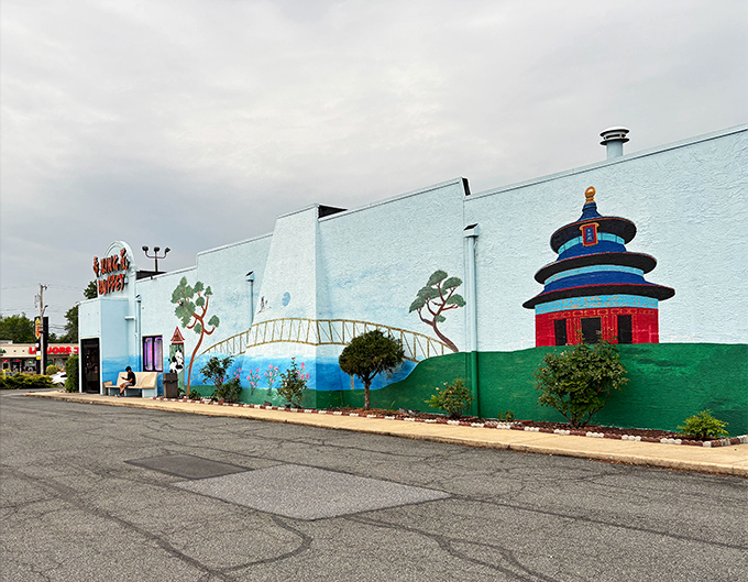 A wider perspective shows the full scope of King Buffet's blue exterior canvas, where Eastern architectural elements create a distinctive landmark on Dover's DuPont Highway.