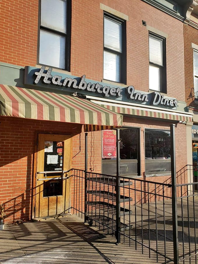 That striped awning isn't just shade &ndash; it's a portal to simpler times when a good burger and conversation were all you needed.
