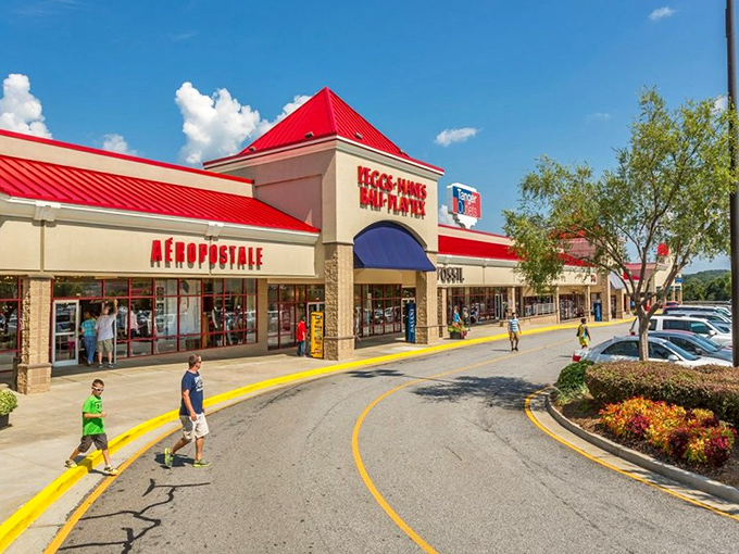 A retail streetscape designed for maximum wallet damage. The curved walkways and vibrant storefronts create an irresistible flow from one sale to the next.