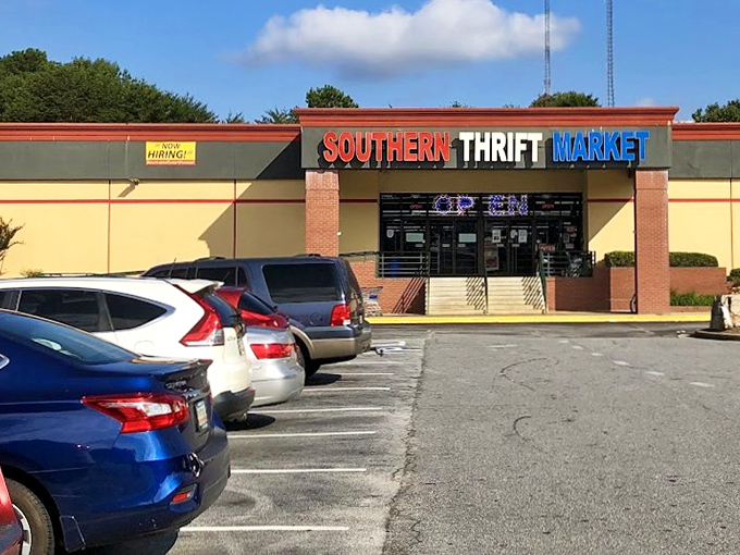The parking lot view that promises adventure within&mdash;where cars wait patiently while their owners discover treasures under that iconic red, white, and blue sign.