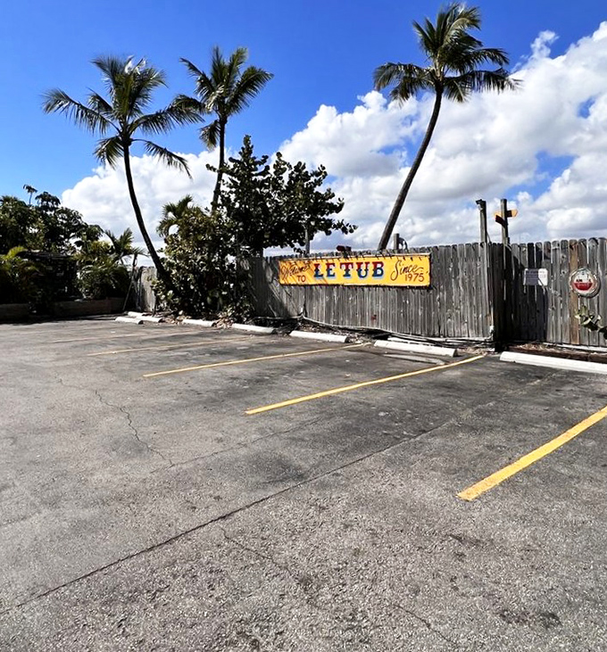 Even the parking lot, framed by swaying palms and that iconic fence, feels like the entrance to a Florida secret worth discovering.