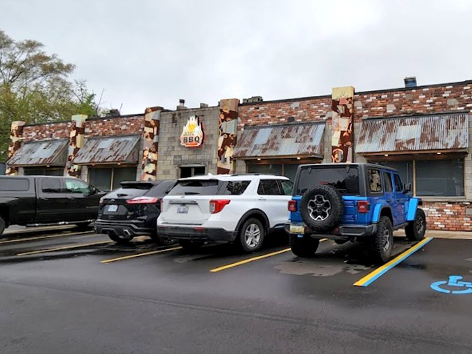 The parking lot view that promises salvation from hunger. Those flames on the building aren't just decoration&mdash;they're a beacon for barbecue pilgrims.