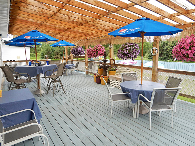 The outdoor patio blooms with color in summer, offering the perfect spot to enjoy a cold one after conquering that prime rib.