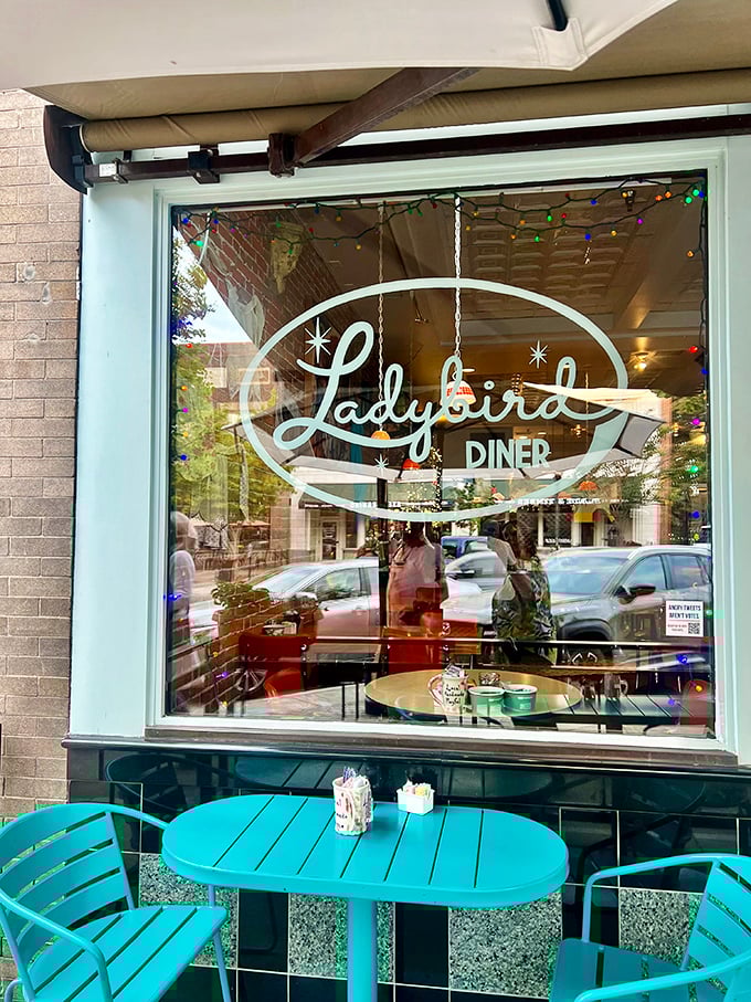 That window sign isn't just a logo&mdash;it's a promise of good things to come, framed by those signature turquoise chairs that say "sit here, stay awhile."
