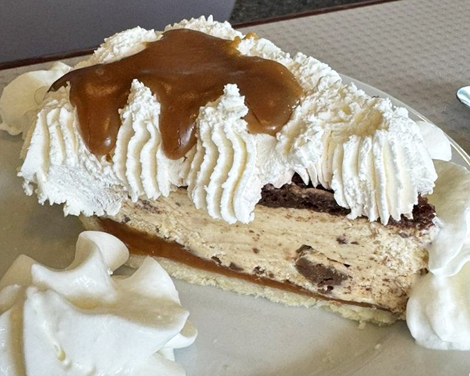 Peanut butter pie with whipped cream sentinels standing guard&mdash;proof that sometimes the most unassuming desserts deliver the most profound joy.