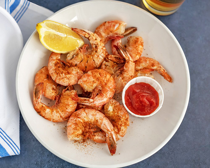 Peel-and-eat shrimp dusted with spices, served with cocktail sauce and lemon. Simple pleasures are often the most satisfying.