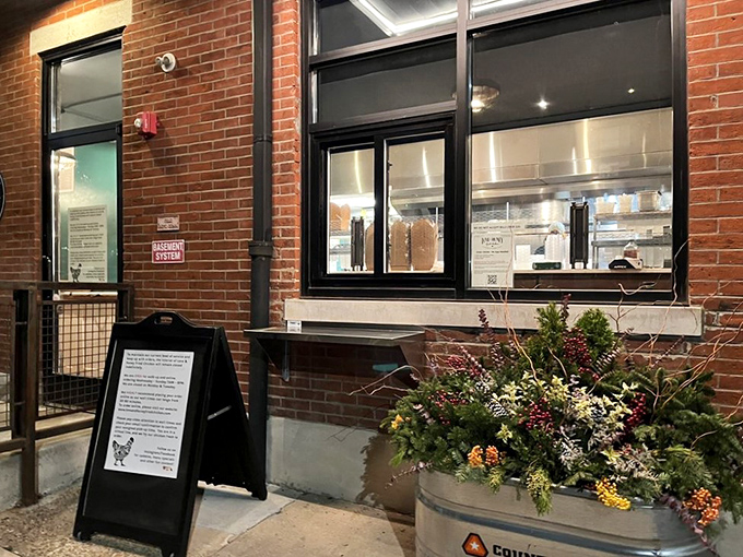 The pickup window, where dreams come true in paper bags. Even the planters outside seem to celebrate your excellent food choices.