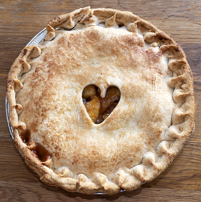 The heart-shaped window in this apple pie crust isn't just cute&mdash;it's a steam vent of love, releasing the aroma of cinnamon-kissed apples that makes resistance futile.