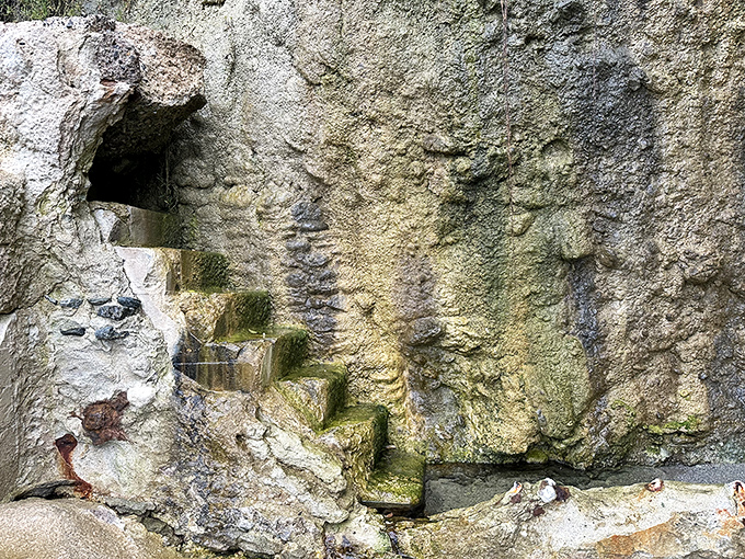 These weathered steps inside the cliff face reveal the tower's true purpose – a fanciful staircase for a wealthy homeowner's beach access.