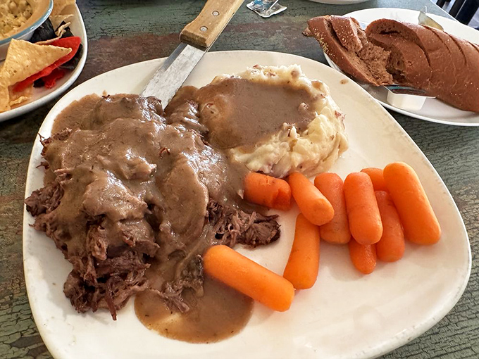 The pot roast dinner isn't just food; it's time travel on a plate &ndash; tender beef, gravy-soaked potatoes, and carrots that taste like someone's grandmother is in the kitchen.