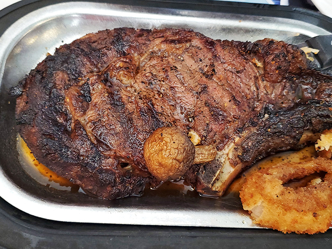 The prime rib doesn't just sit on the plate—it commands attention, a carnivore's dream that makes vegetarians briefly question their life choices.