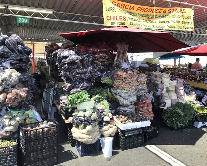 A spice merchant's dream stall where aromatics meet fresh produce. This sensory explosion offers everything needed to transform ordinary meals into extraordinary culinary experiences.