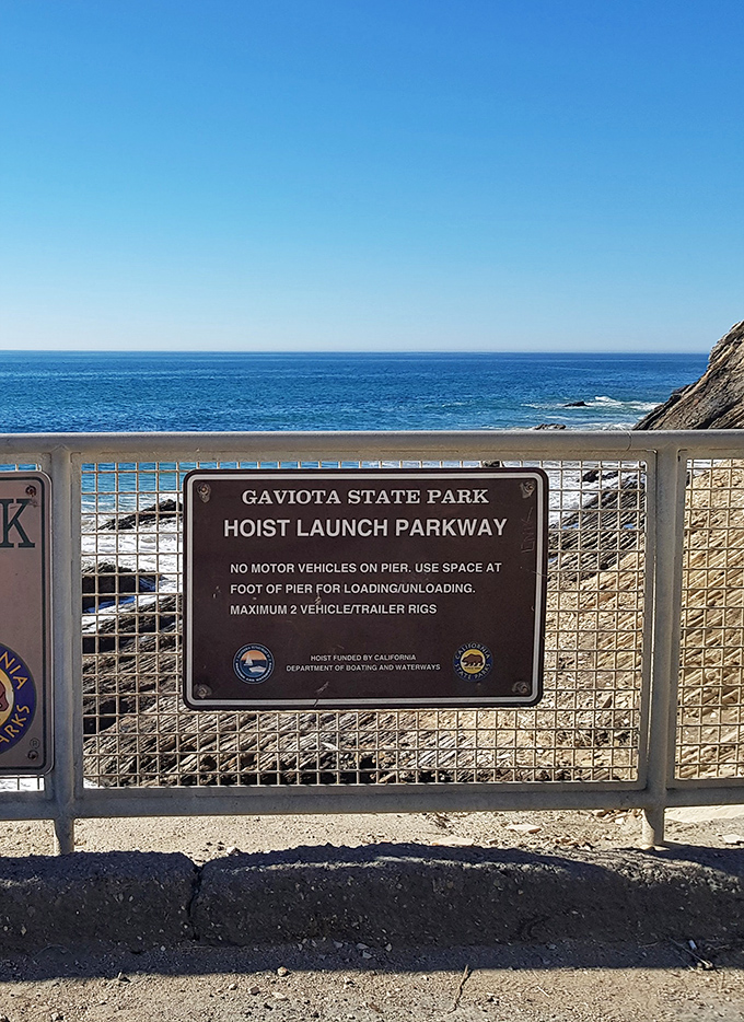 The boat launch facility reminds visiting anglers that rules exist, but also that adventure awaits just beyond the pier.