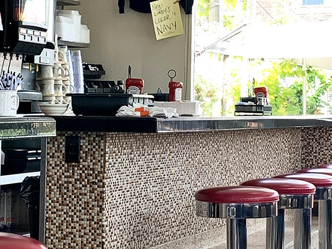 The mosaic-tiled counter where coffee cups are constantly refilled and local gossip flows as freely as the cream&mdash;the true heart of any great American diner.