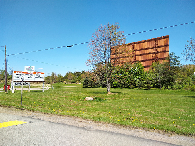 A daytime glimpse of cinema history. This unassuming roadside view transforms into movie magic when darkness falls.