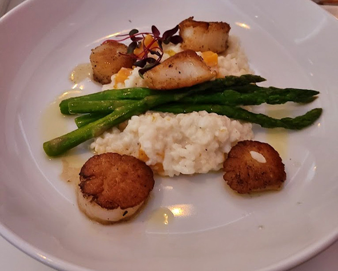 The risotto whispering sweet nothings to perfectly seared scallops. A plate that proves simplicity and luxury aren't mutually exclusive.