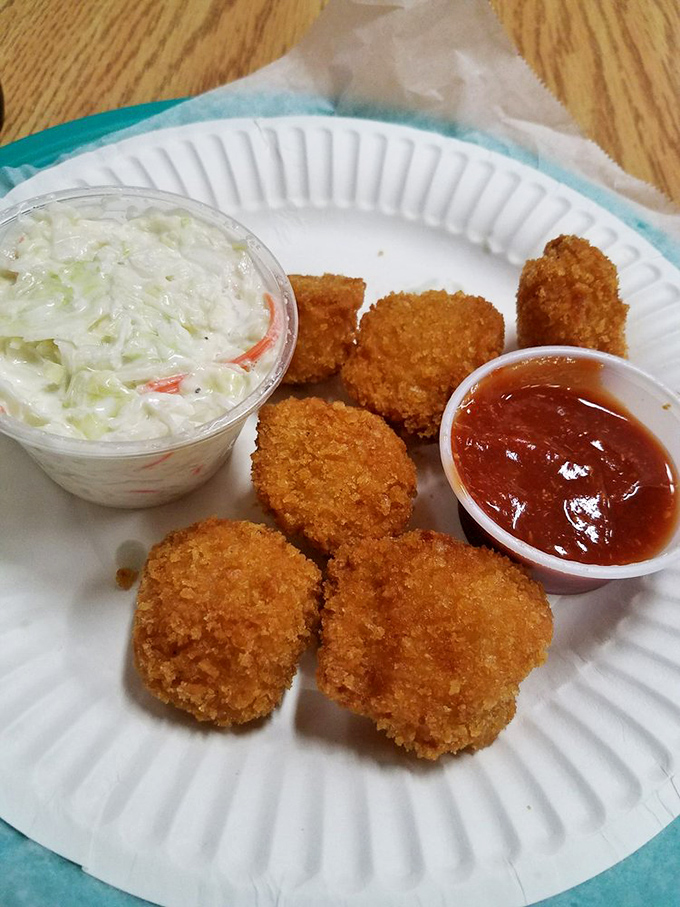 Golden-fried scallops with all the fixings. These crispy morsels paired with creamy coleslaw and tangy cocktail sauce are simple perfection on a paper plate.