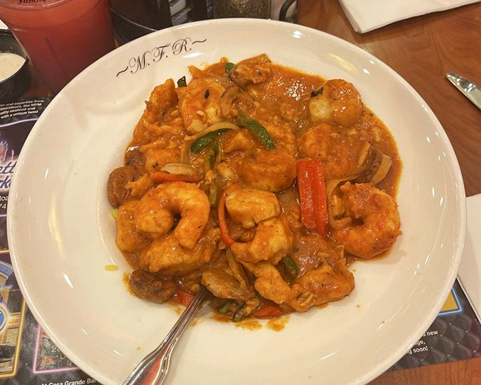 The seafood jambalaya arrives like a spicy celebration, each shrimp a guest of honor at a party of flavors that's just getting started.