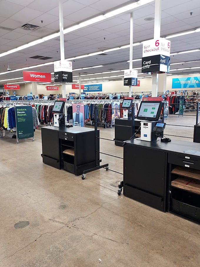 Self-checkout stations stand ready for your treasure haul. The "Reduce, Reuse, Repeat" sign perfectly captures the thrift store philosophy in three simple words.