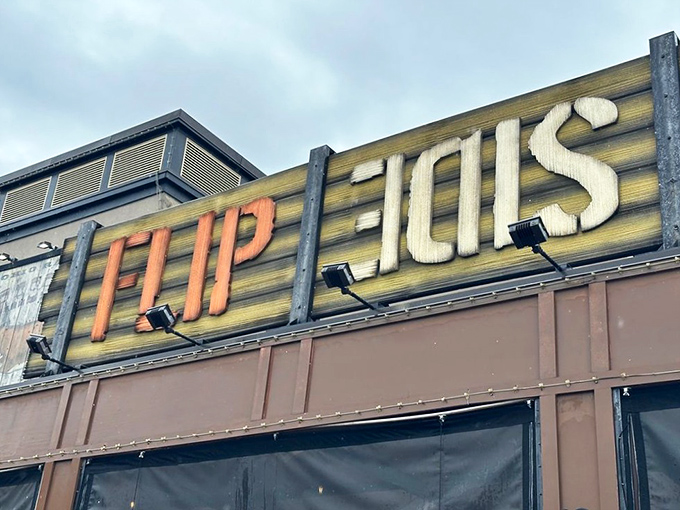 The illuminated sign serves as a beacon for burger enthusiasts. Like a lighthouse guiding hungry sailors to safe harbor.