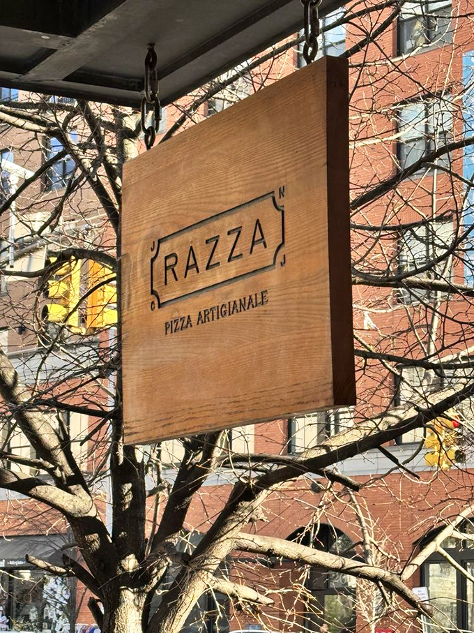 The wooden sign swinging gently outside &ndash; "Pizza Artigianale" isn't just Italian for artisanal pizza, it's a philosophy that guides every aspect of Razza.