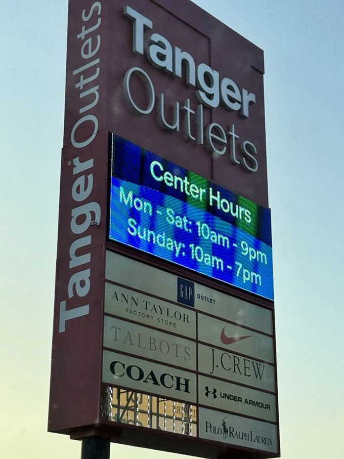 The towering Tanger sign broadcasts designer names like a roll call of fashion royalty, with extended hours for serious shoppers.