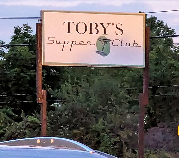 The iconic sign stands as a beacon for hungry travelers and locals alike, promising Wisconsin hospitality in liquid and solid forms.