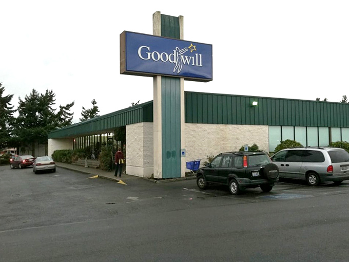 The classic Goodwill storefront stands proudly against Washington's evergreen backdrop, a temple to sustainable shopping and unexpected treasures.