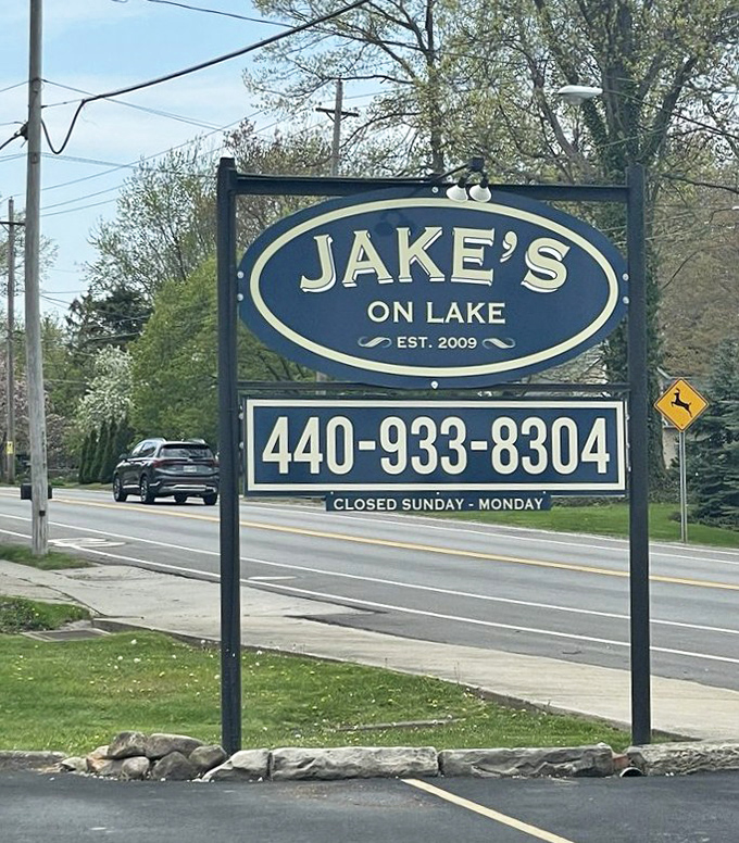 The sign stands proud along the roadside, a blue oval beacon guiding hungry travelers to their delicious destination.
